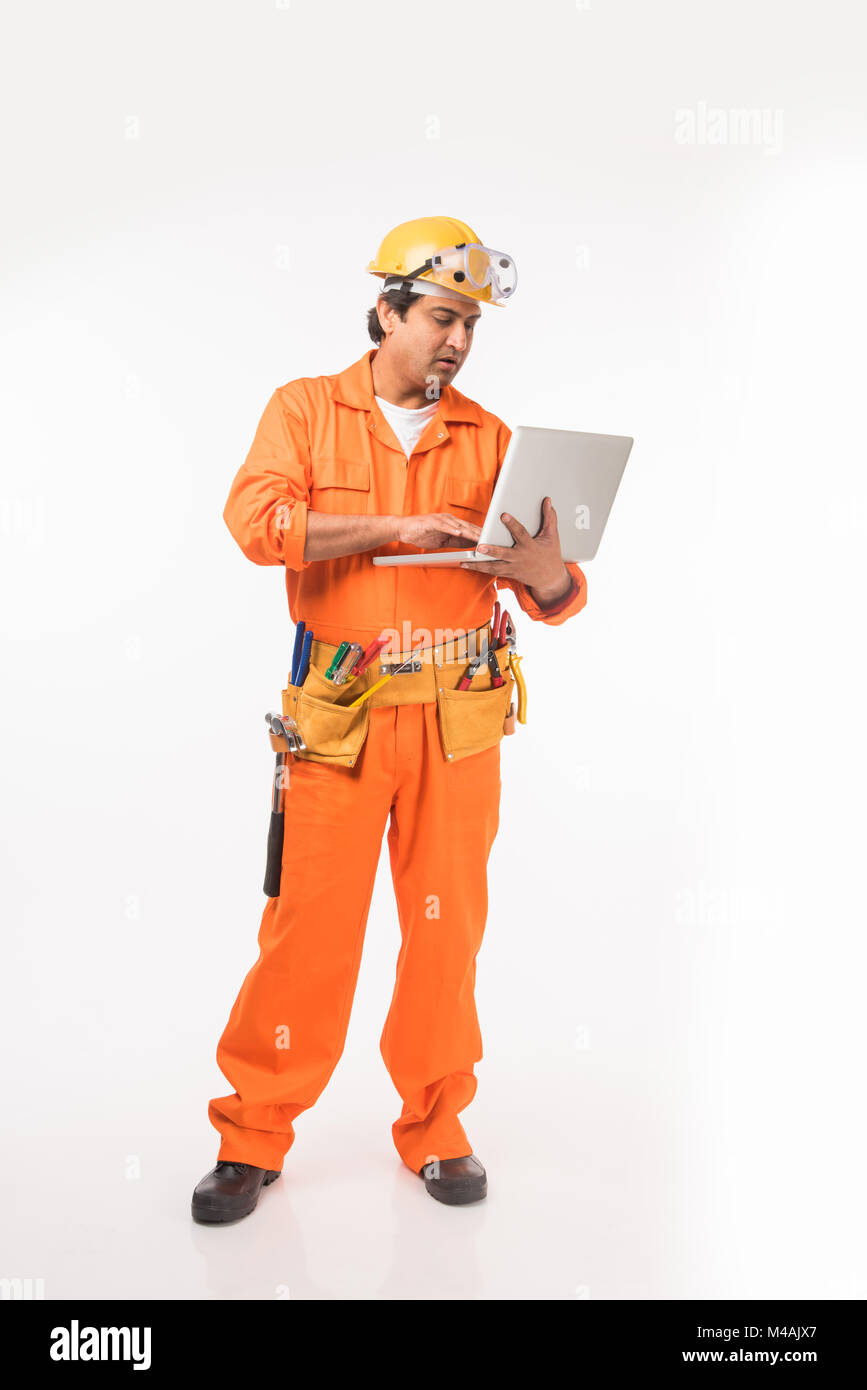 Indian electrician engineer in action with wire cutter, drilling ...