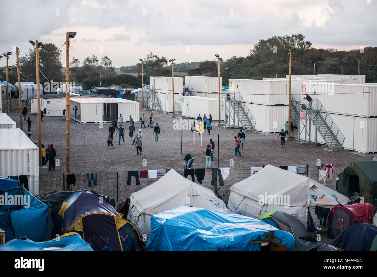 People inside the shelter made of shipping containers playing football ...