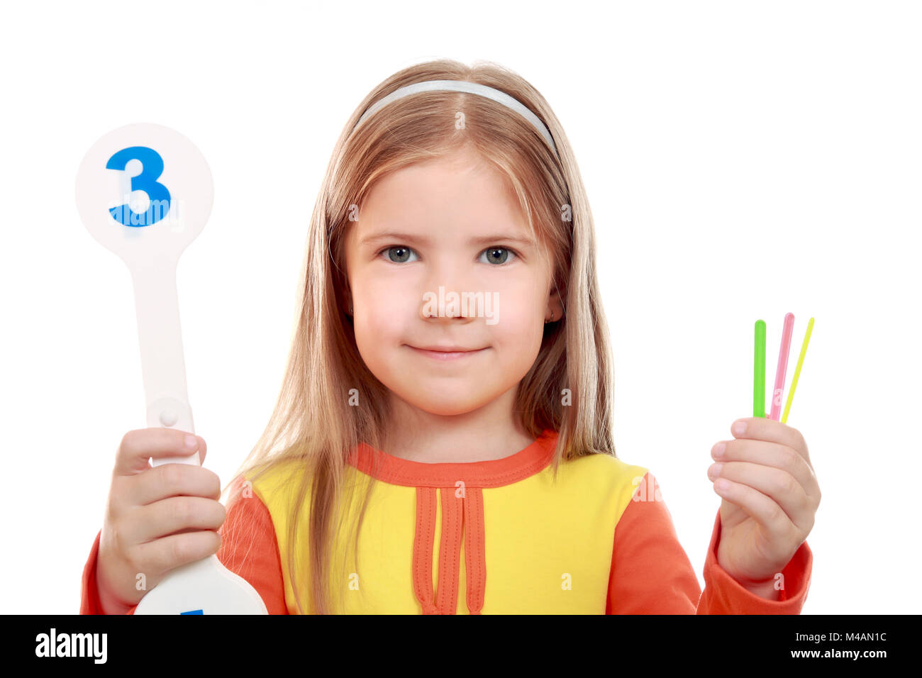 A preschool girl is learning numerals and numeracy. Shows the digit ...
