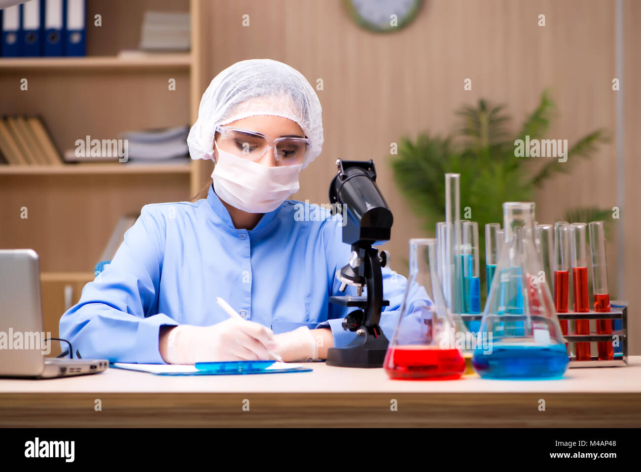 Lab chemist working with microscope and tubes Stock Photo - Alamy