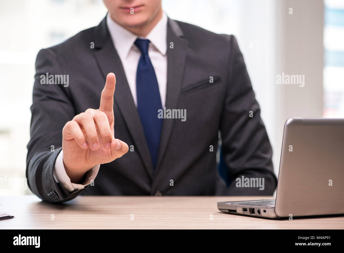 Young businessman pressing buttons in business concept Stock Photo - Alamy
