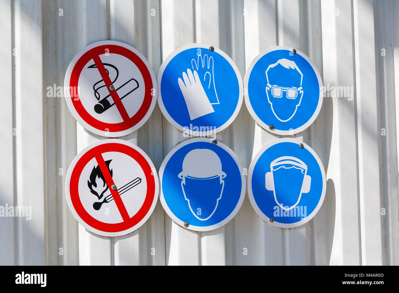 Warning signs on the wall Stock Photo - Alamy