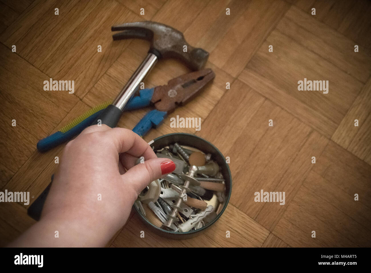 A close-up of a woman's hand with nails and some tools Stock Photo - Alamy