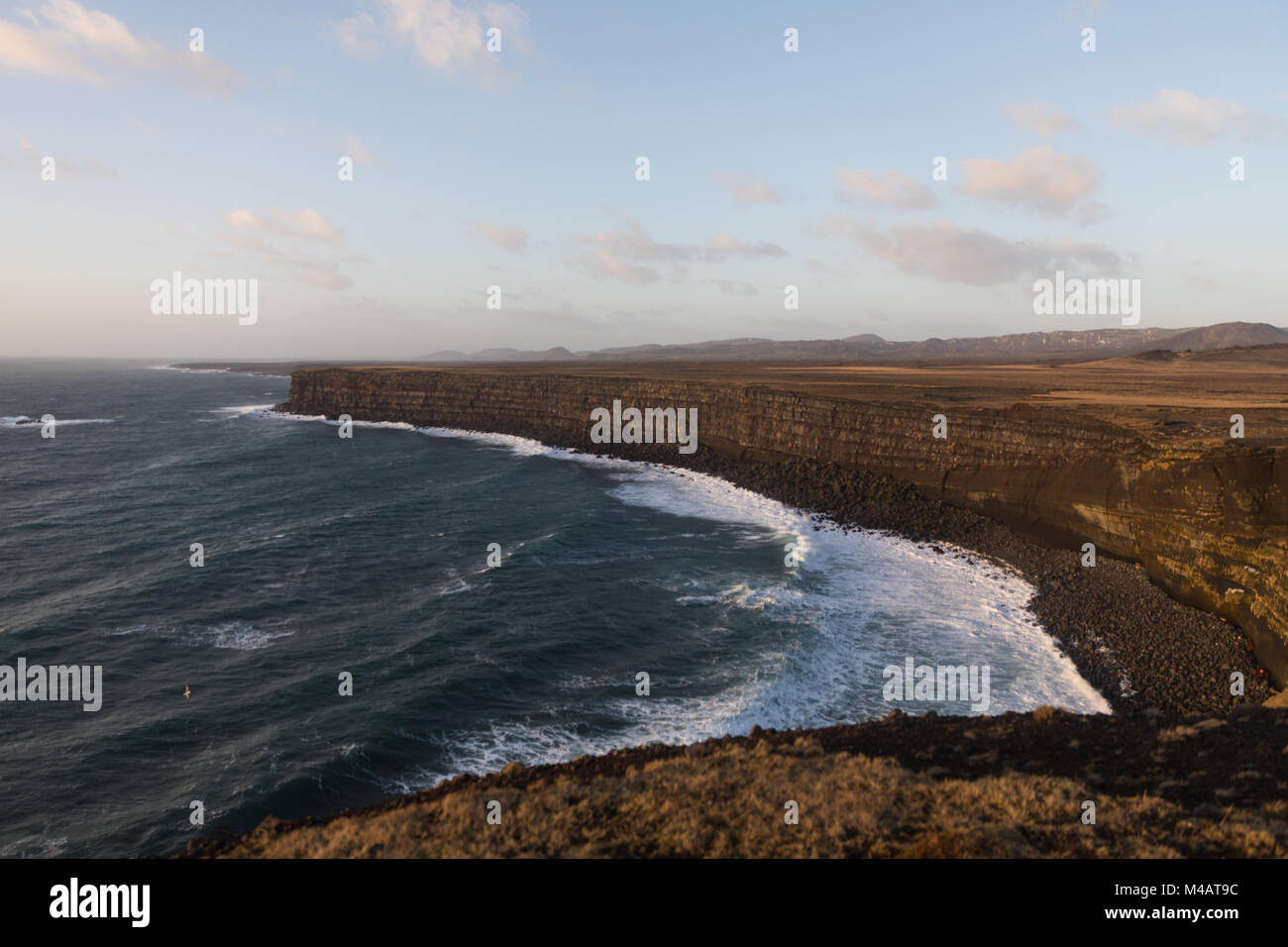 Atlantic Ocean waves crash against the rocky Krisuvikurberg Cliffs on ...