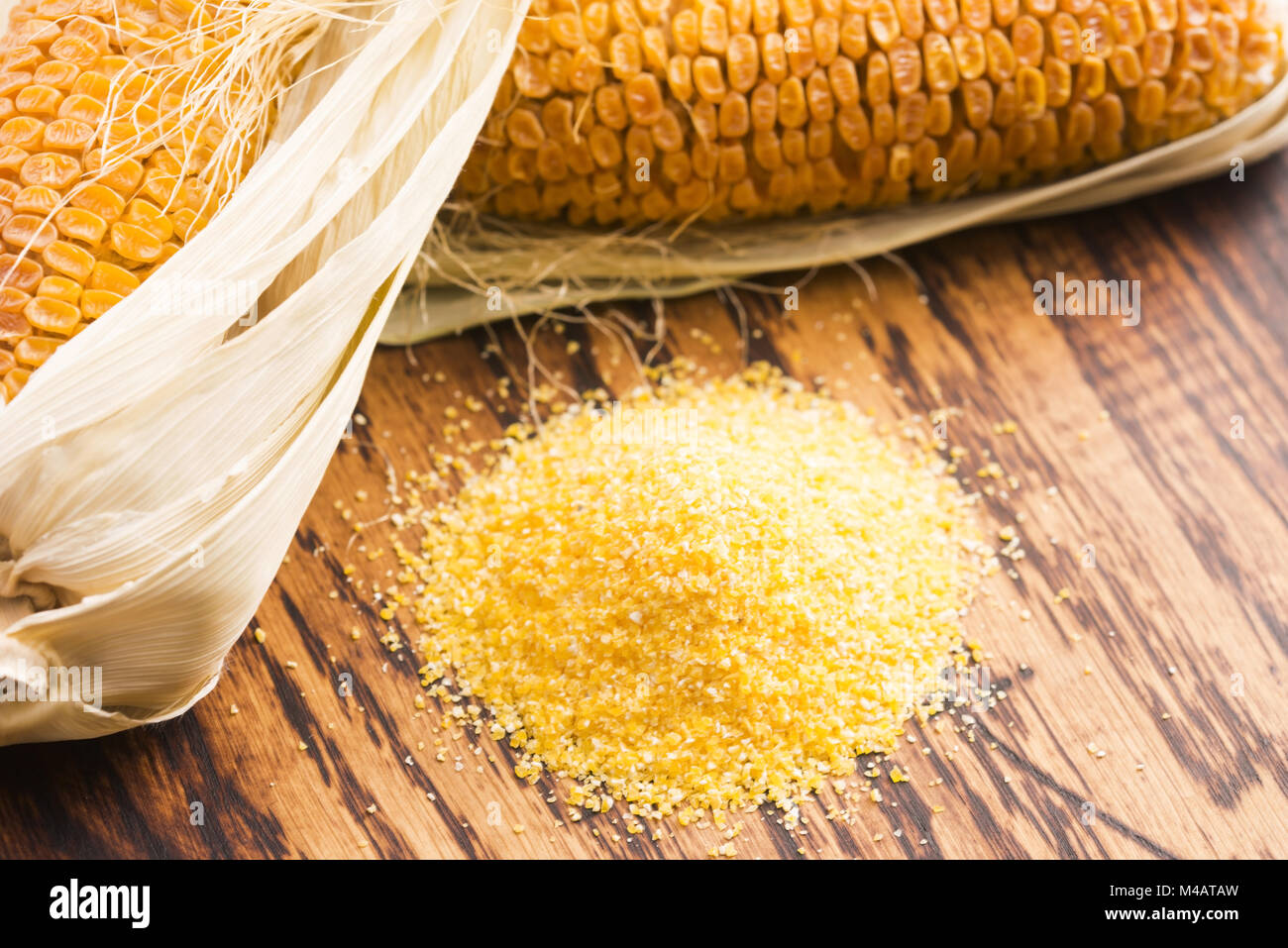 Corn groats and seeds, corncobs on wooden rustic table Stock Photo - Alamy