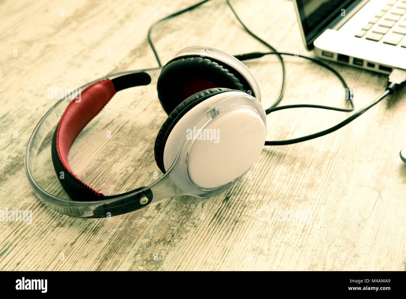 Headphones and a Laptop computer on a Desktop Stock Photo - Alamy