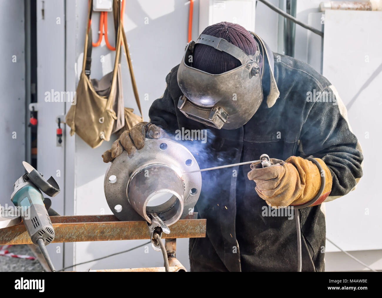 Manual arc welding conical transition with a skirted flange Stock Photo ...