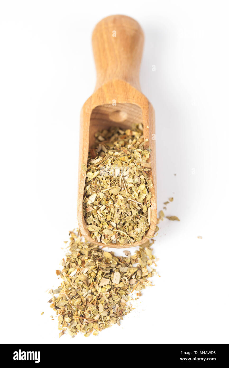 Dry Oregano herb in wood scoop on white background Stock Photo - Alamy