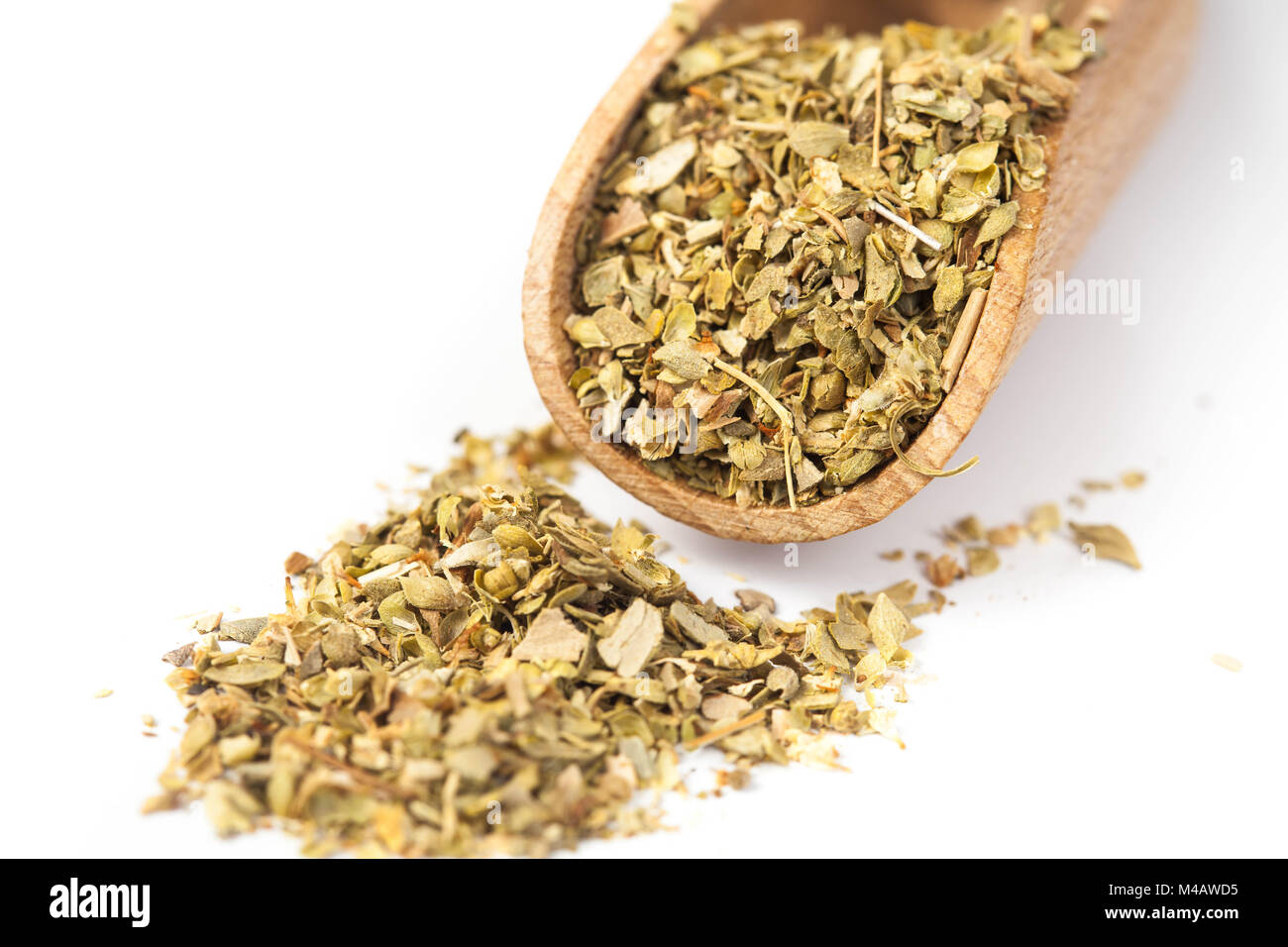 Dry Oregano herb in wood scoop on white background Stock Photo - Alamy