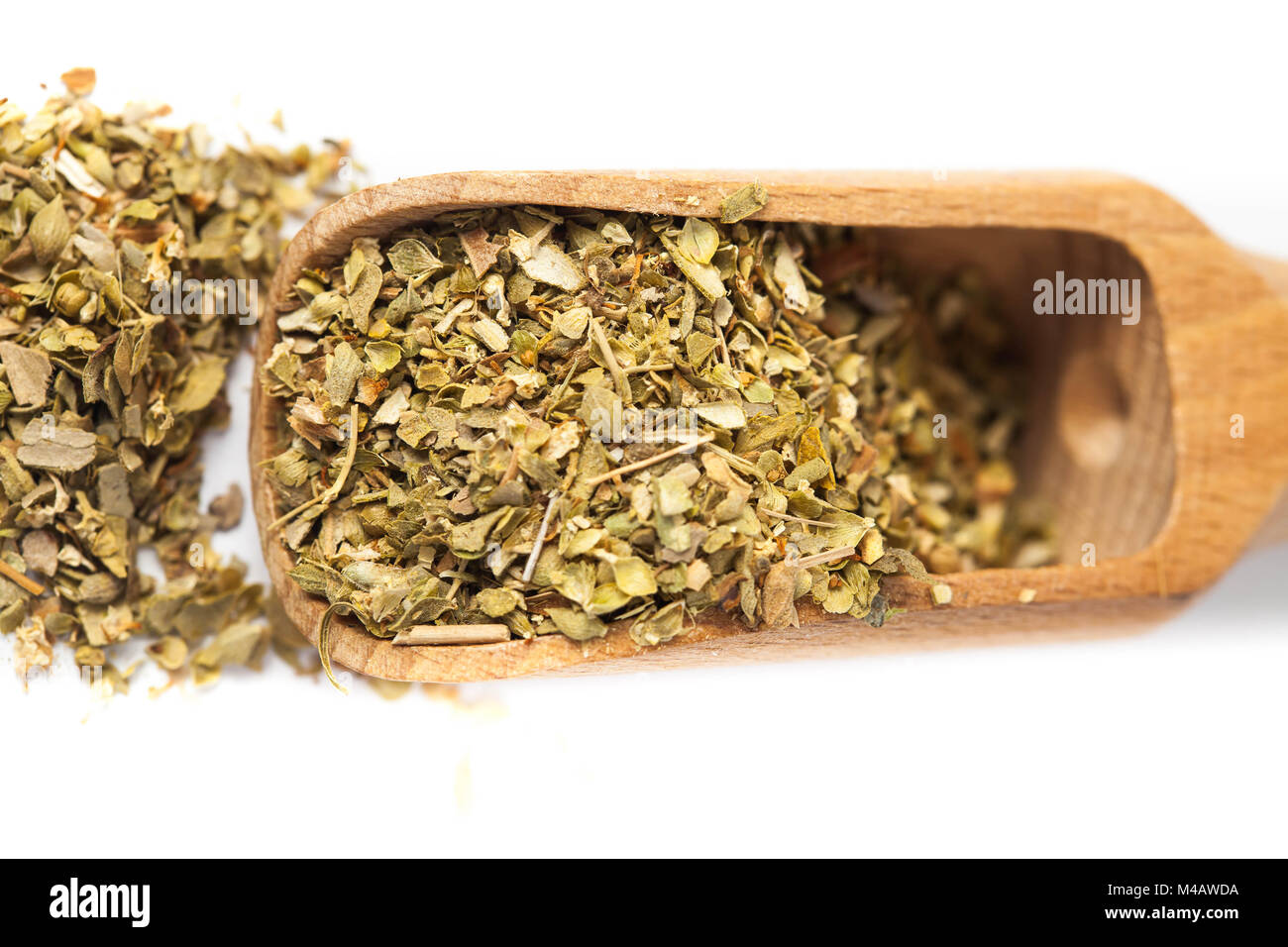 Dry Oregano herb in wood scoop on white background Stock Photo - Alamy