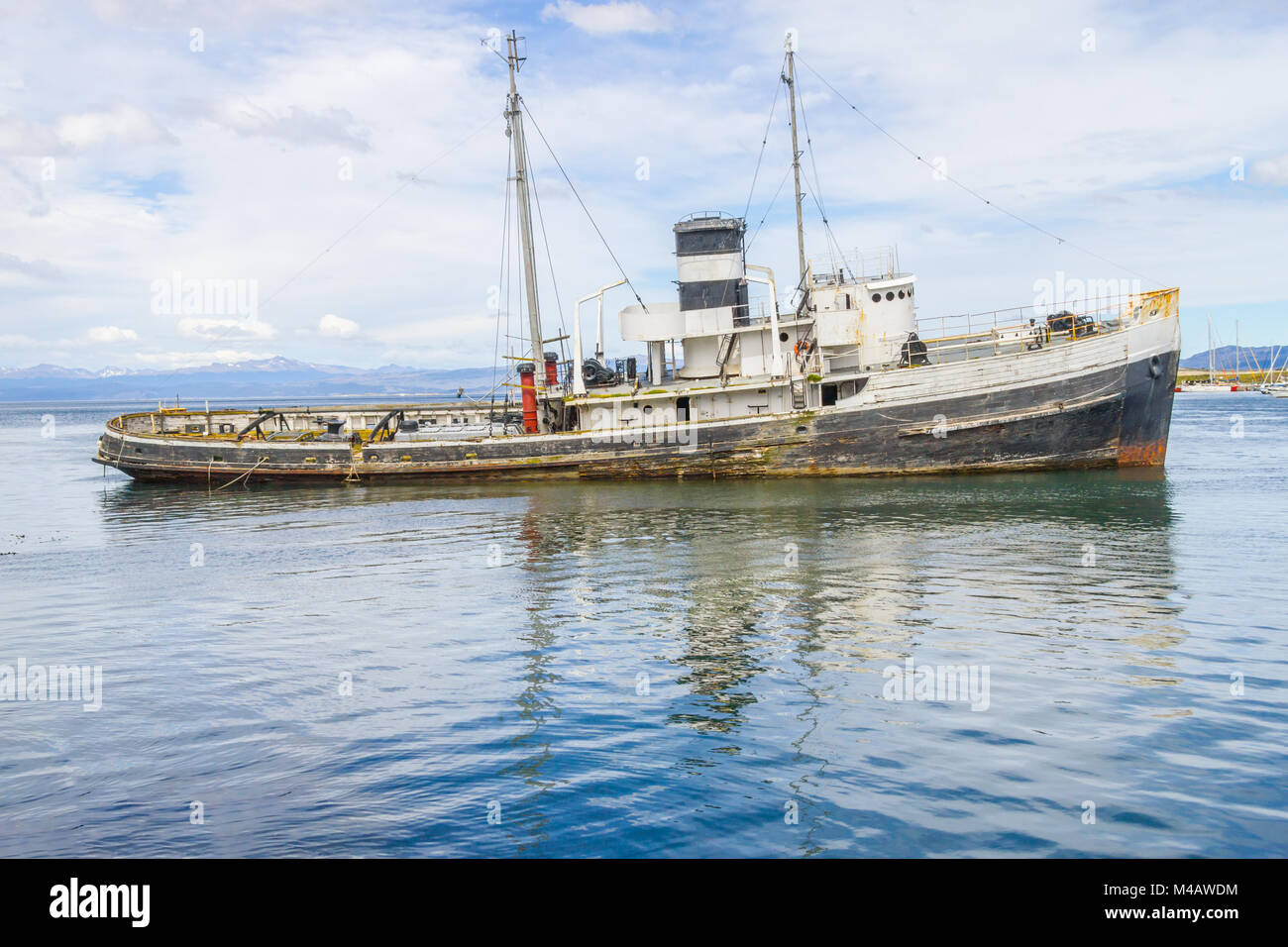 Old boat in Beagle channel with mountains in Ushuaia, Patagonia ...