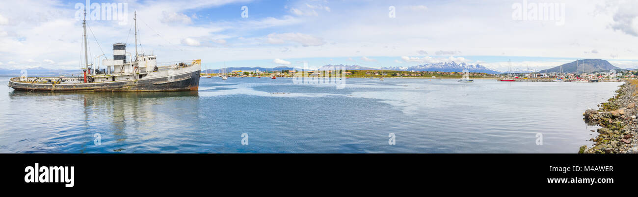 Old boat in Beagle channel with mountains in Ushuaia, Patagonia ...