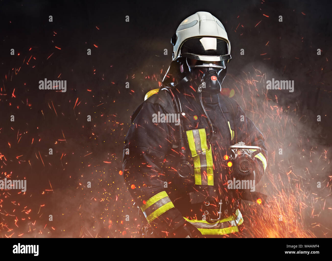 A firefighter dressed in a uniform in a studio Stock Photo - Alamy