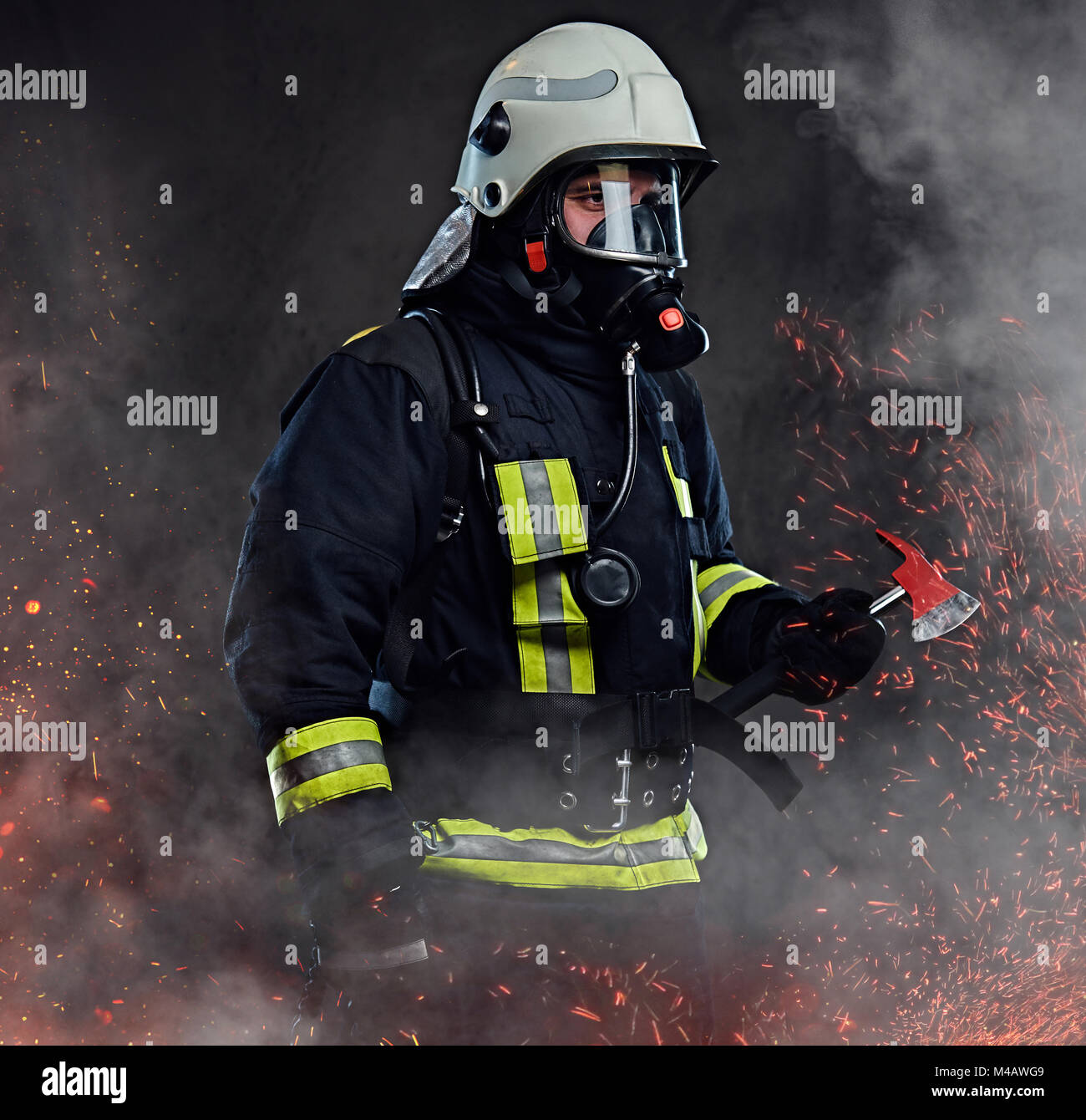 A firefighter dressed in a uniform in a studio Stock Photo - Alamy