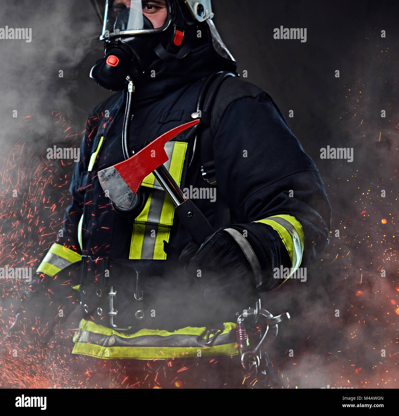 A firefighter dressed in a uniform in a studio Stock Photo - Alamy