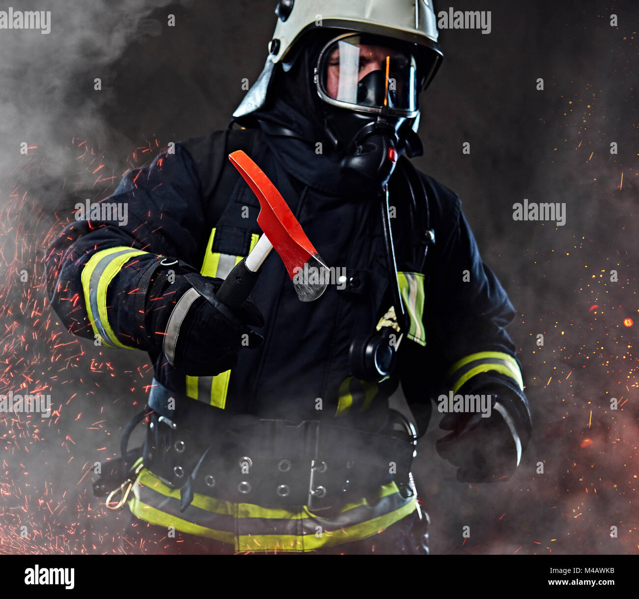 A firefighter dressed in a uniform in a studio Stock Photo - Alamy