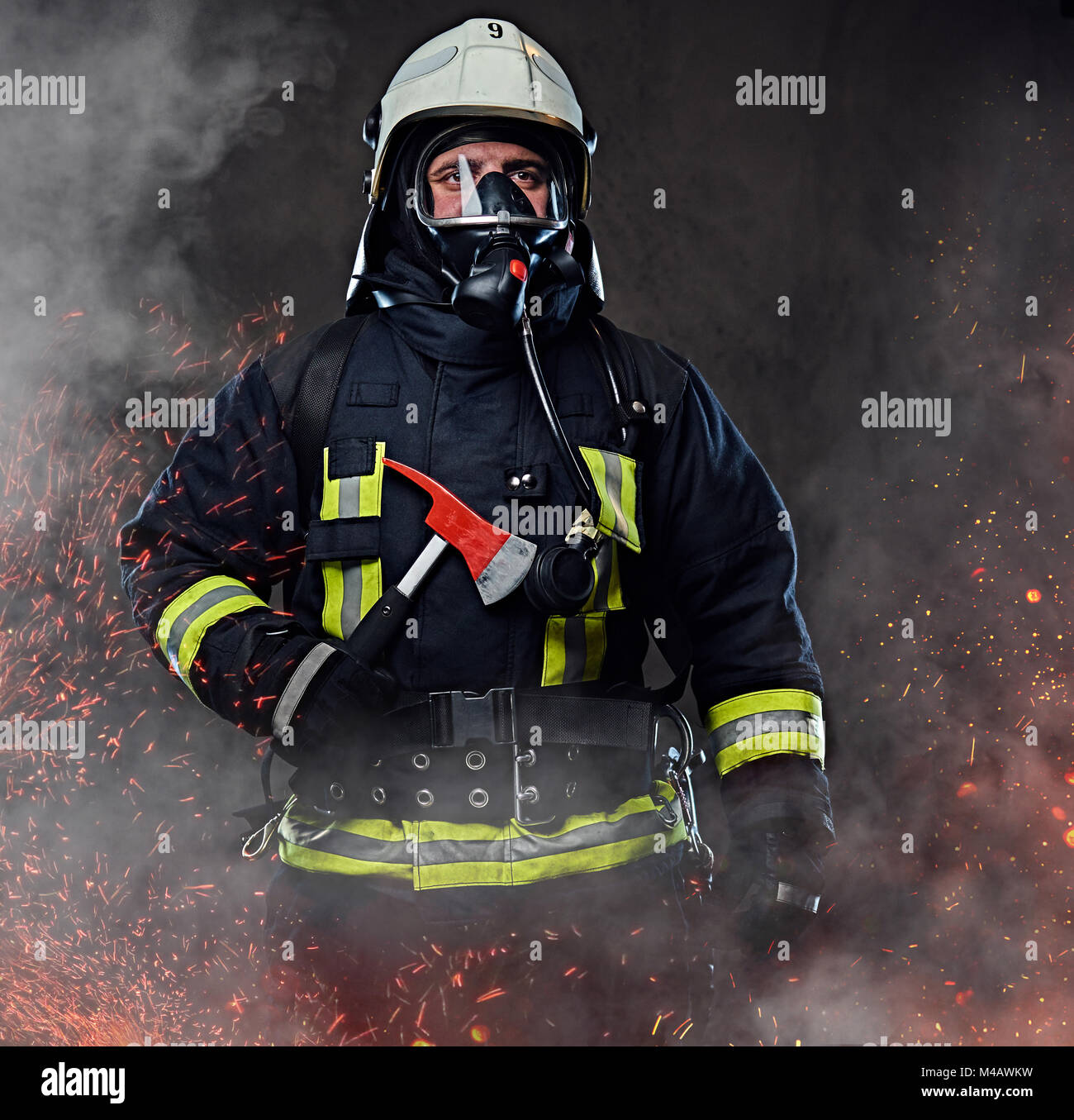 A firefighter dressed in a uniform in a studio Stock Photo - Alamy