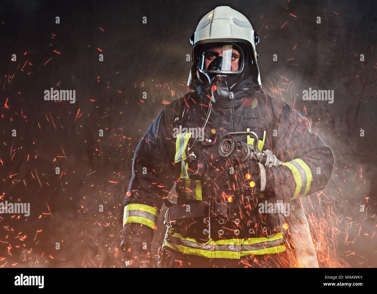 A firefighter dressed in a uniform in a studio Stock Photo - Alamy
