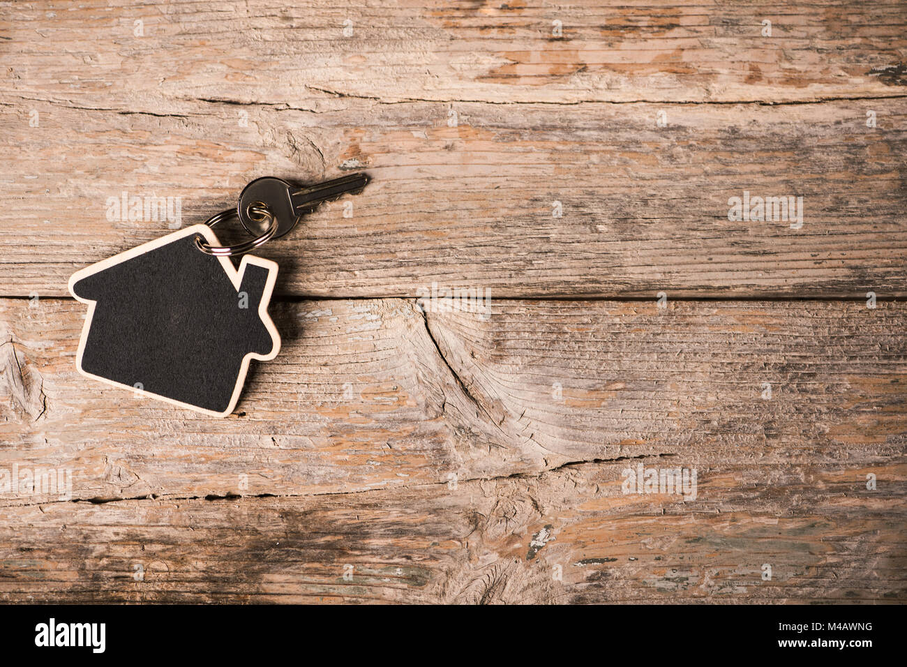 House-shaped key on a wood rustic table Stock Photo - Alamy