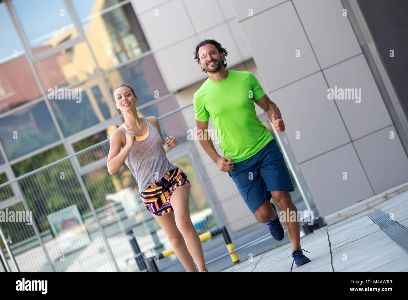 Couple running in urban enviroment at hot summer day Stock Photo - Alamy