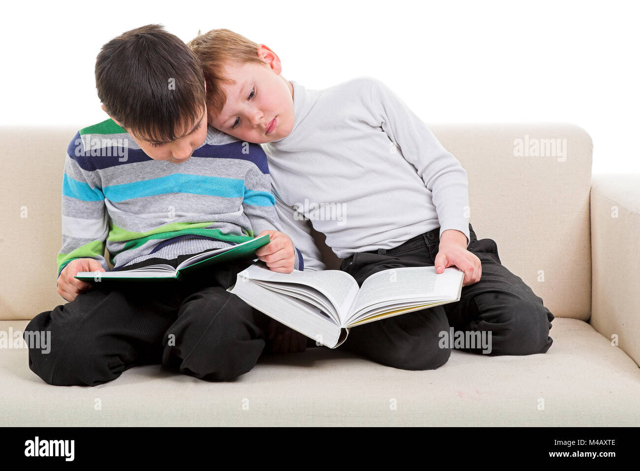 Two boys reading big book Stock Photo - Alamy