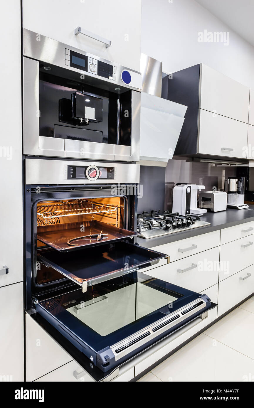 Modern hi-tek kitchen, oven with door open Stock Photo - Alamy