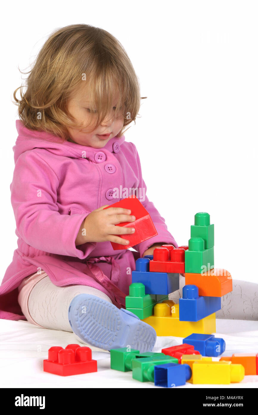 beauty a little girl with colorful blocks on white background Stock ...