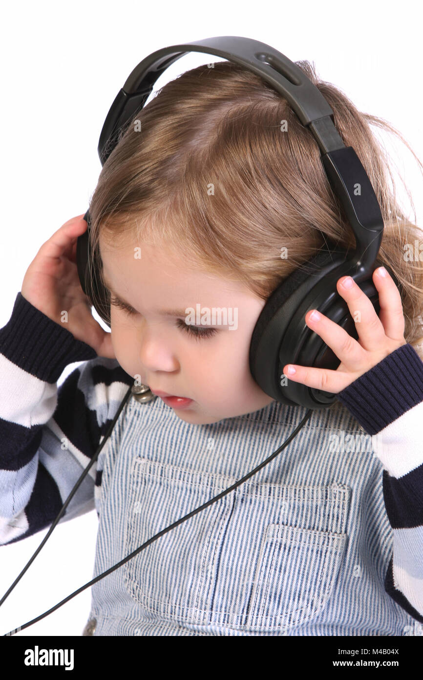 beauty a little girl listening music on white background Stock Photo ...