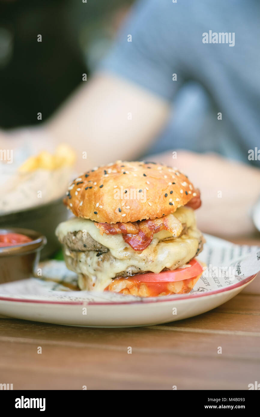 Cheeseburger in outdoor restaurant Stock Photo - Alamy