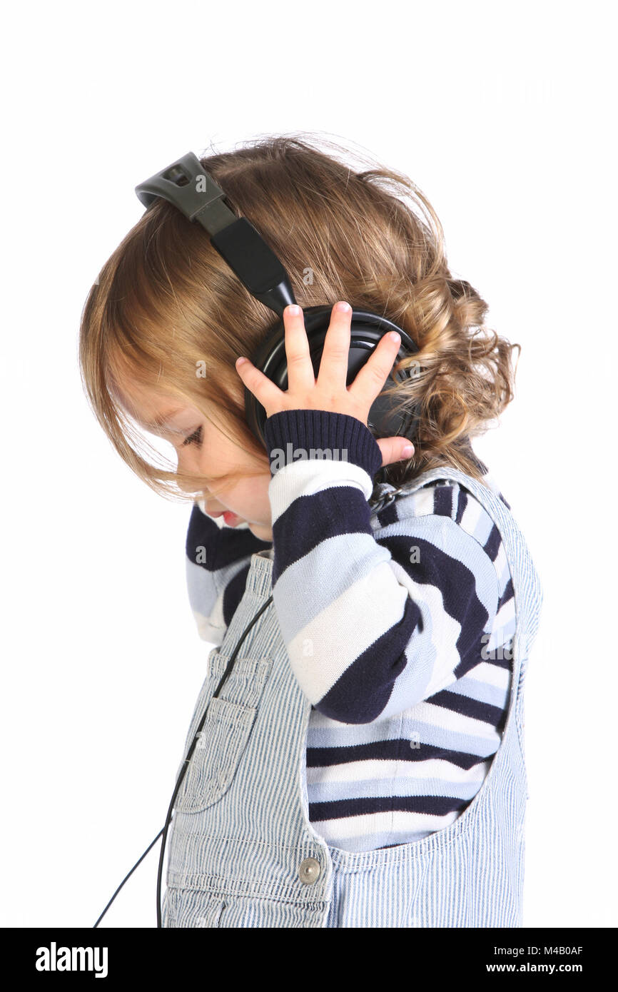 beauty a little girl listening music on white background Stock Photo ...