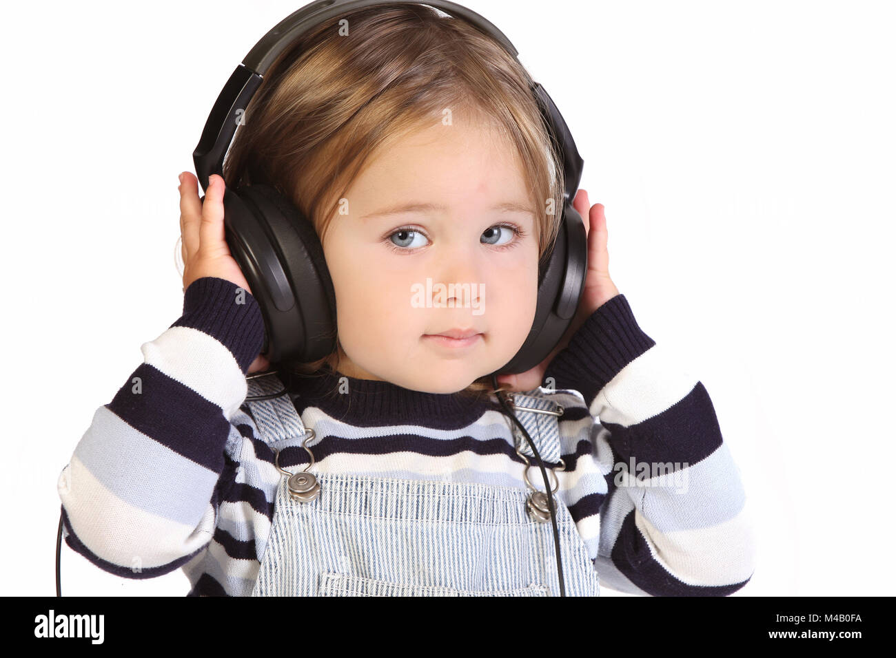 beauty a little girl listening music on white background Stock Photo ...