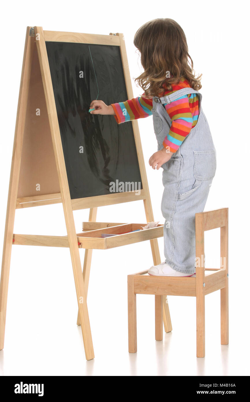 beauty a little girl writing on a blackboard Stock Photo - Alamy