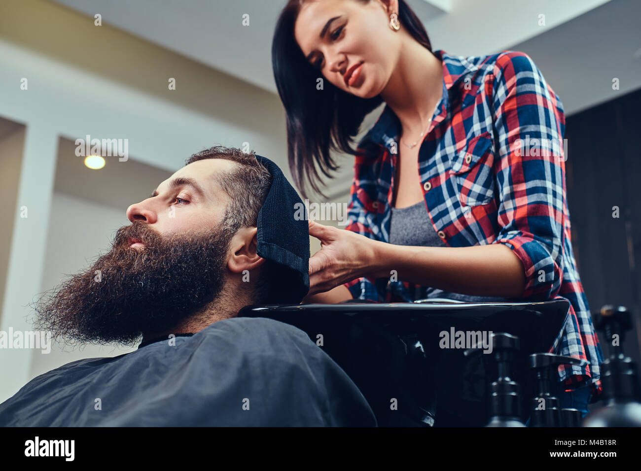 Handsome bearded man in the barbershop Stock Photo - Alamy