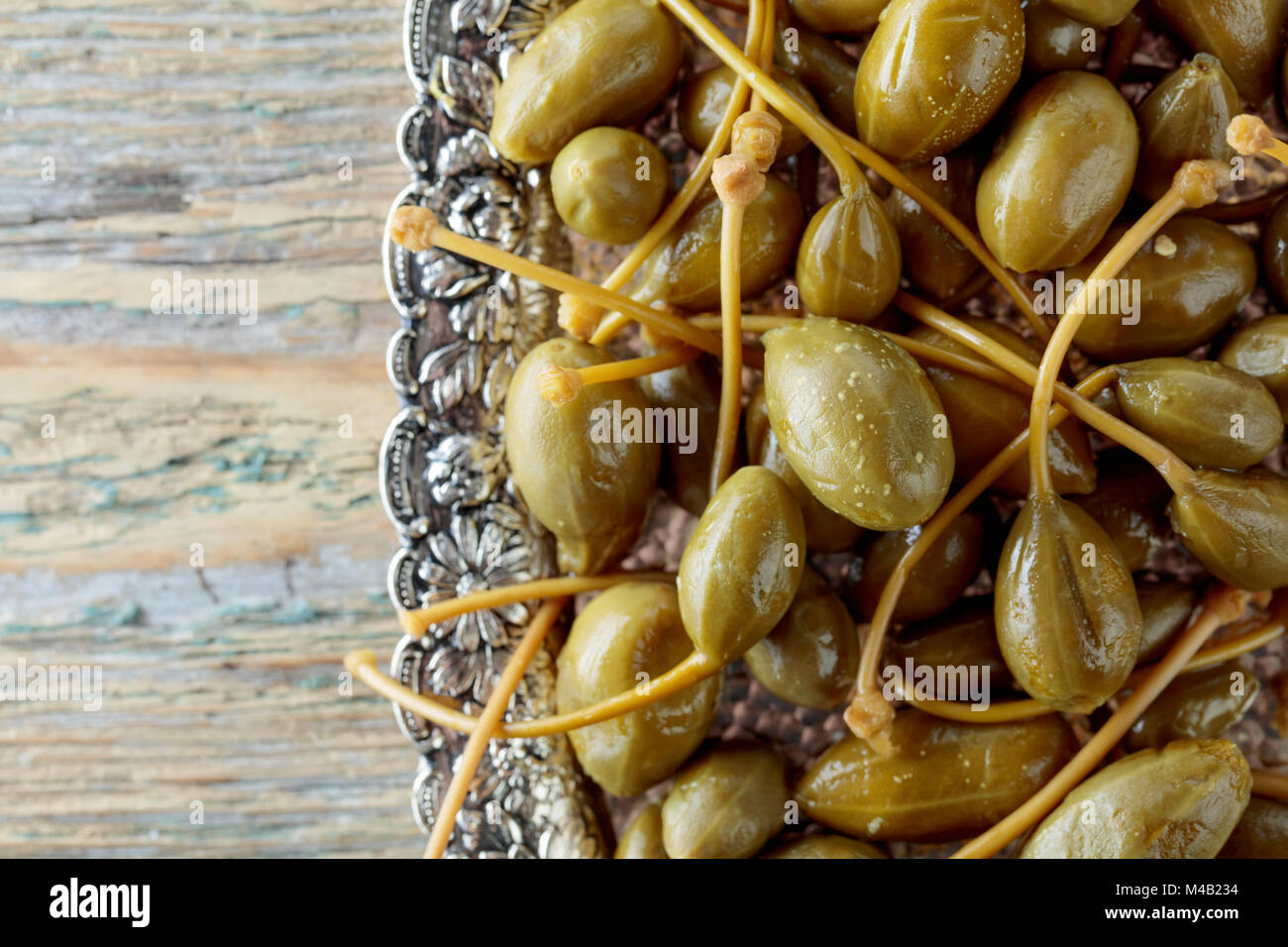 Pickled caper berries in metal dish . Edible fruits of Capparis ...