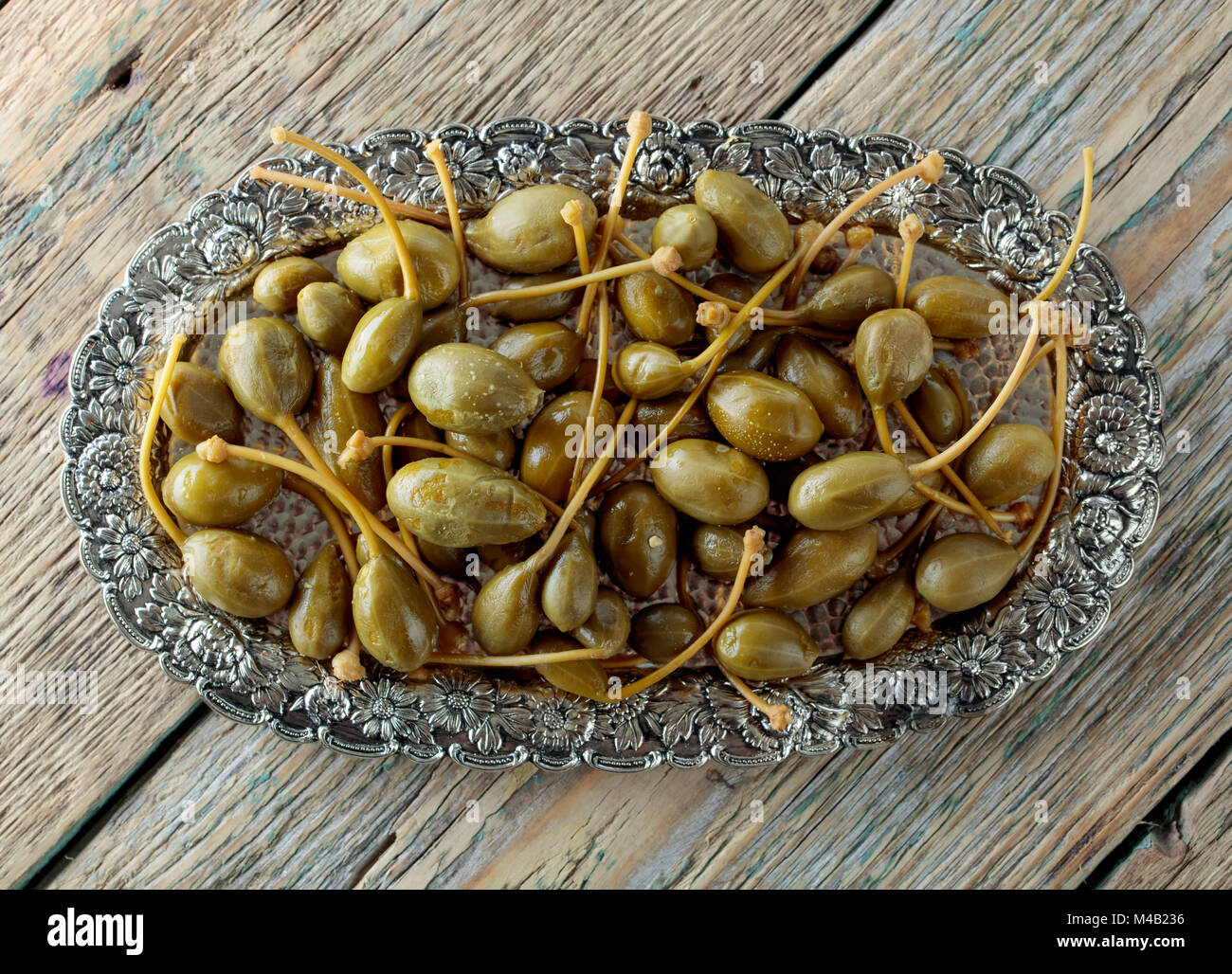 Pickled caper berries in metal dish . Edible fruits of Capparis ...