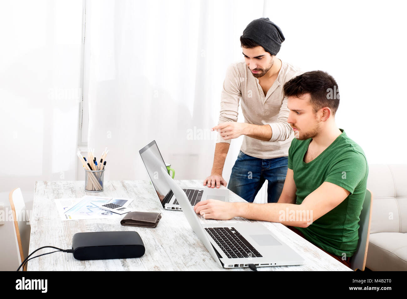 Two co-workers discussing something in the office Stock Photo - Alamy