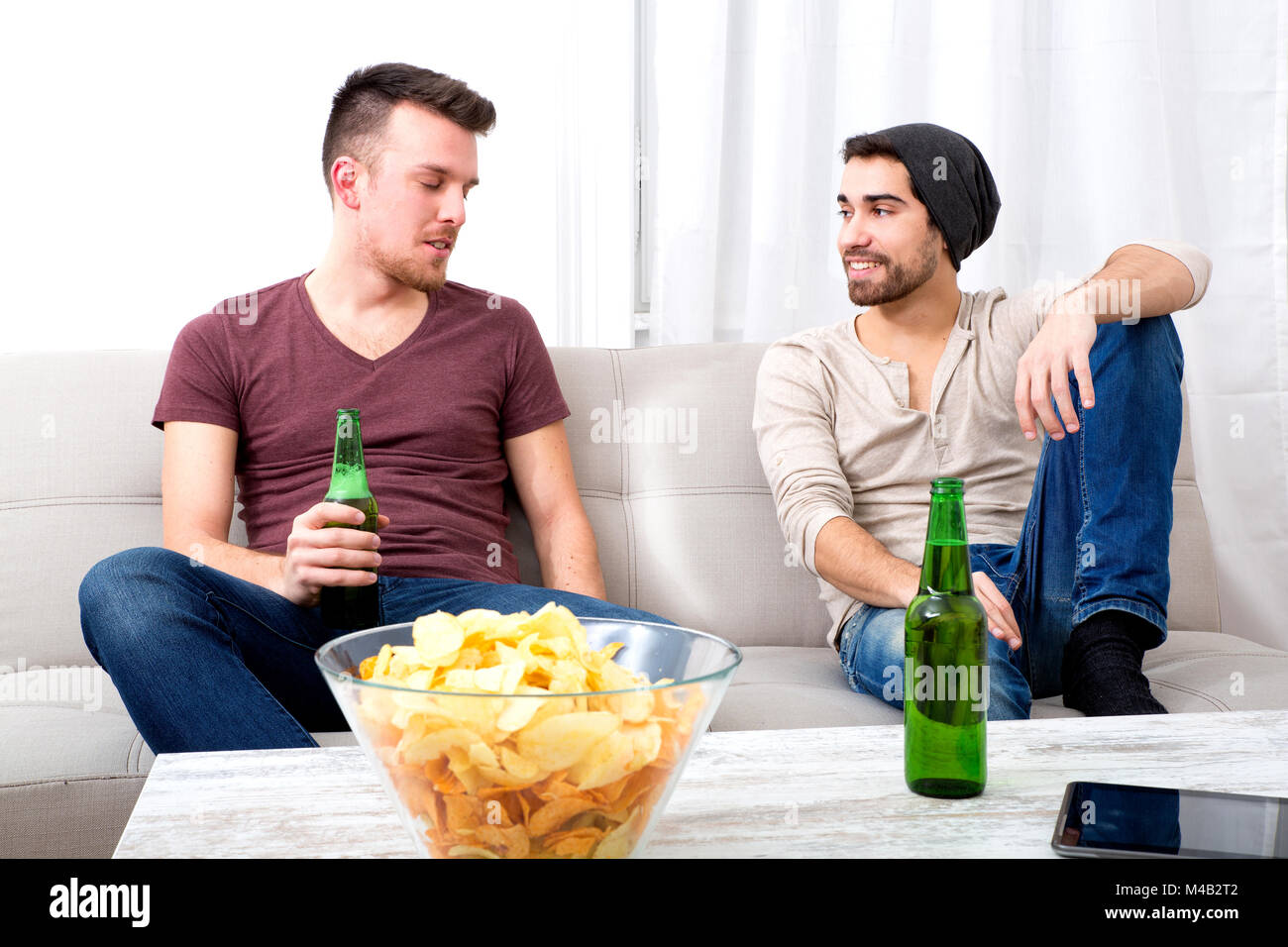 Two Friends having a conversation in the living room Stock Photo - Alamy