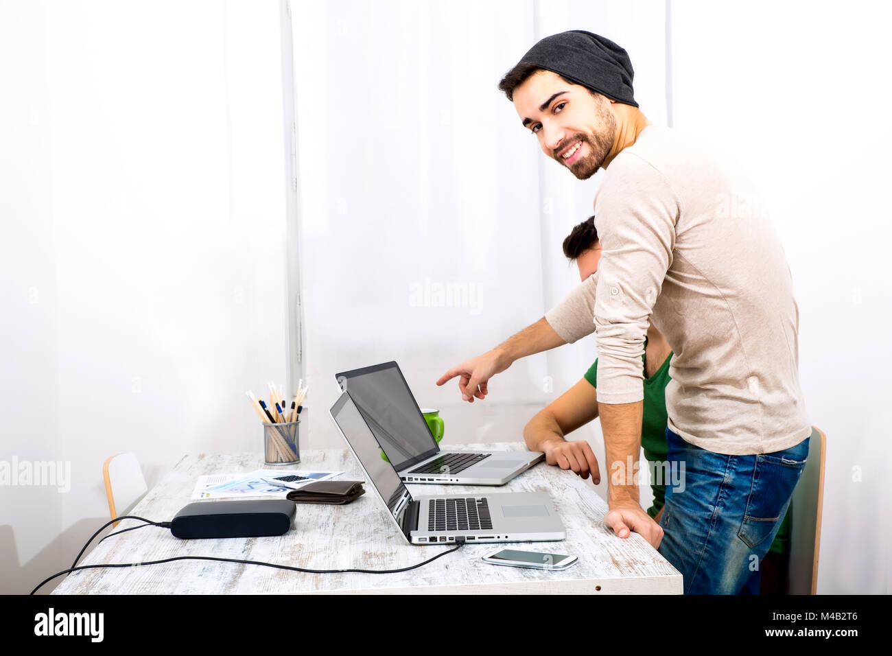 Two co-workers discussing something in the office Stock Photo - Alamy