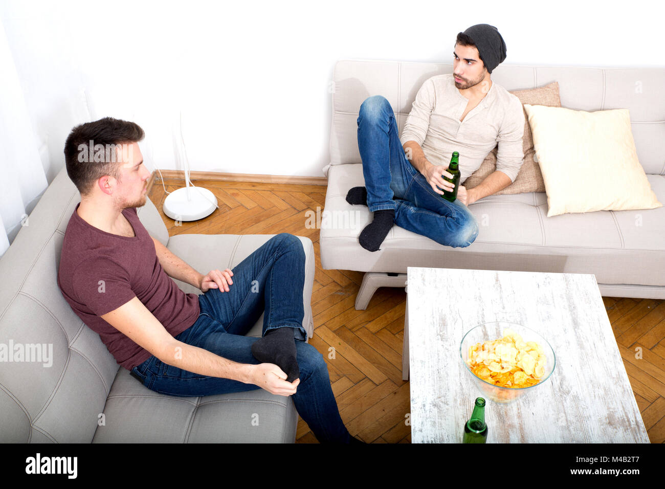 Two Friends having a conversation in the living room Stock Photo - Alamy