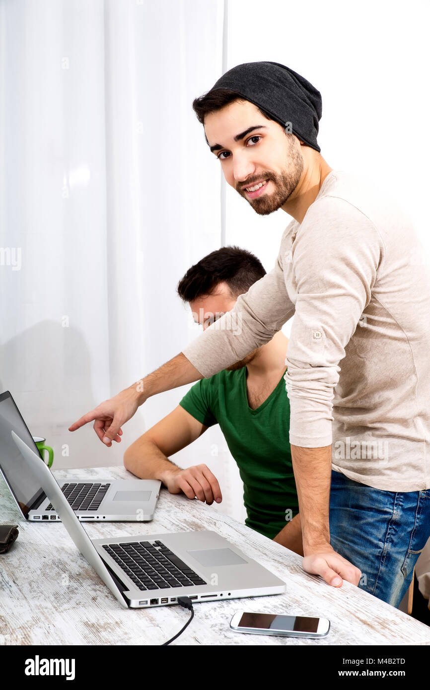 Two co-workers discussing something in the office Stock Photo - Alamy