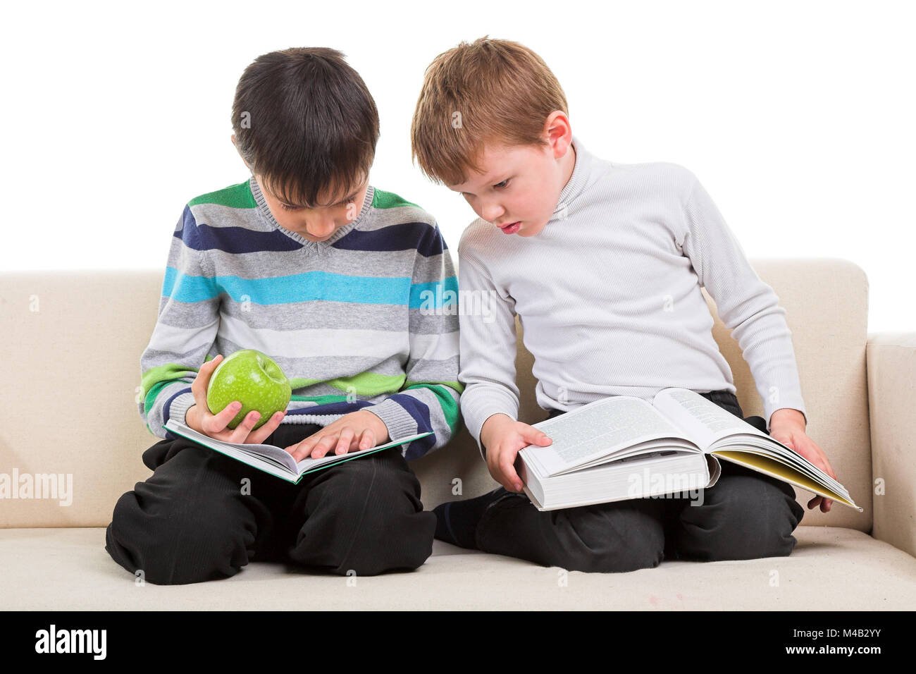 Two boys reading big book Stock Photo - Alamy