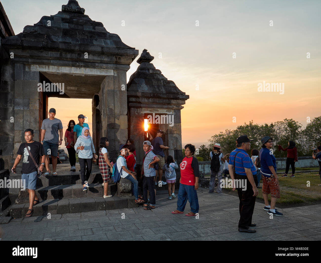 Tourists at the main gate of Ratu Boko Palace compound at sunset ...