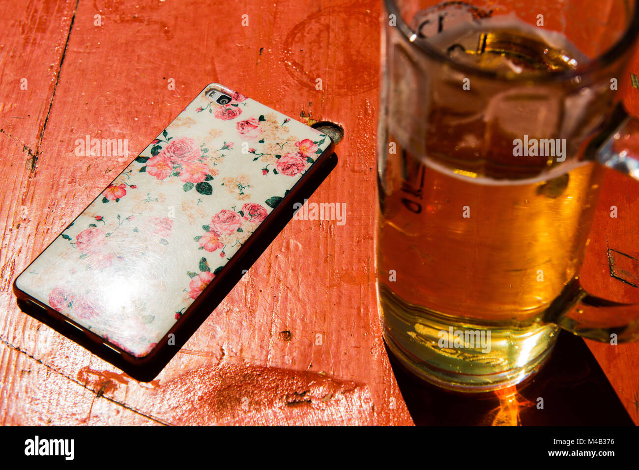 Mobile phone on a beer table Stock Photo - Alamy