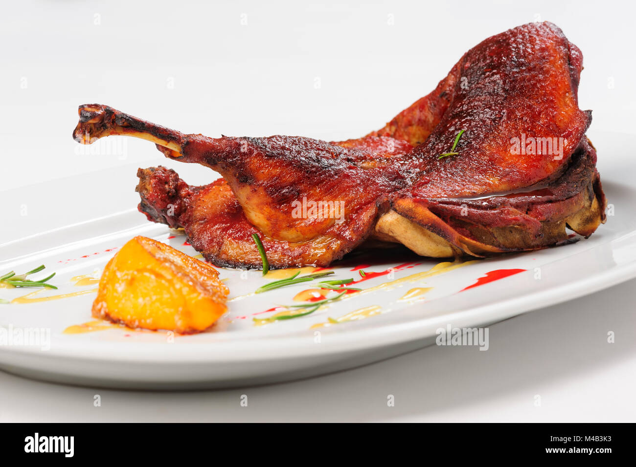 Roast half of duck with caramelized lemon Stock Photo - Alamy