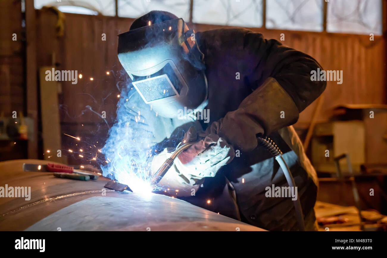 Semi-automatic welding with sparks and smoke Stock Photo - Alamy