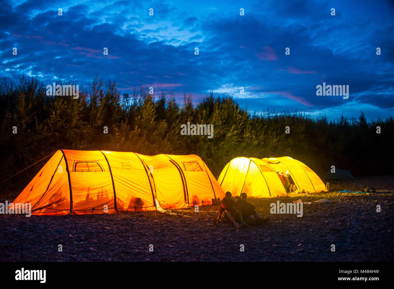 Illuminated tent at nighttime near the bystraya river hi-res stock ...