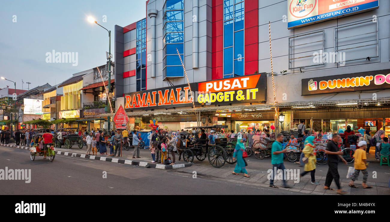 Facades of shops illuminated at dusk. Malioboro Street, Yogyakarta ...