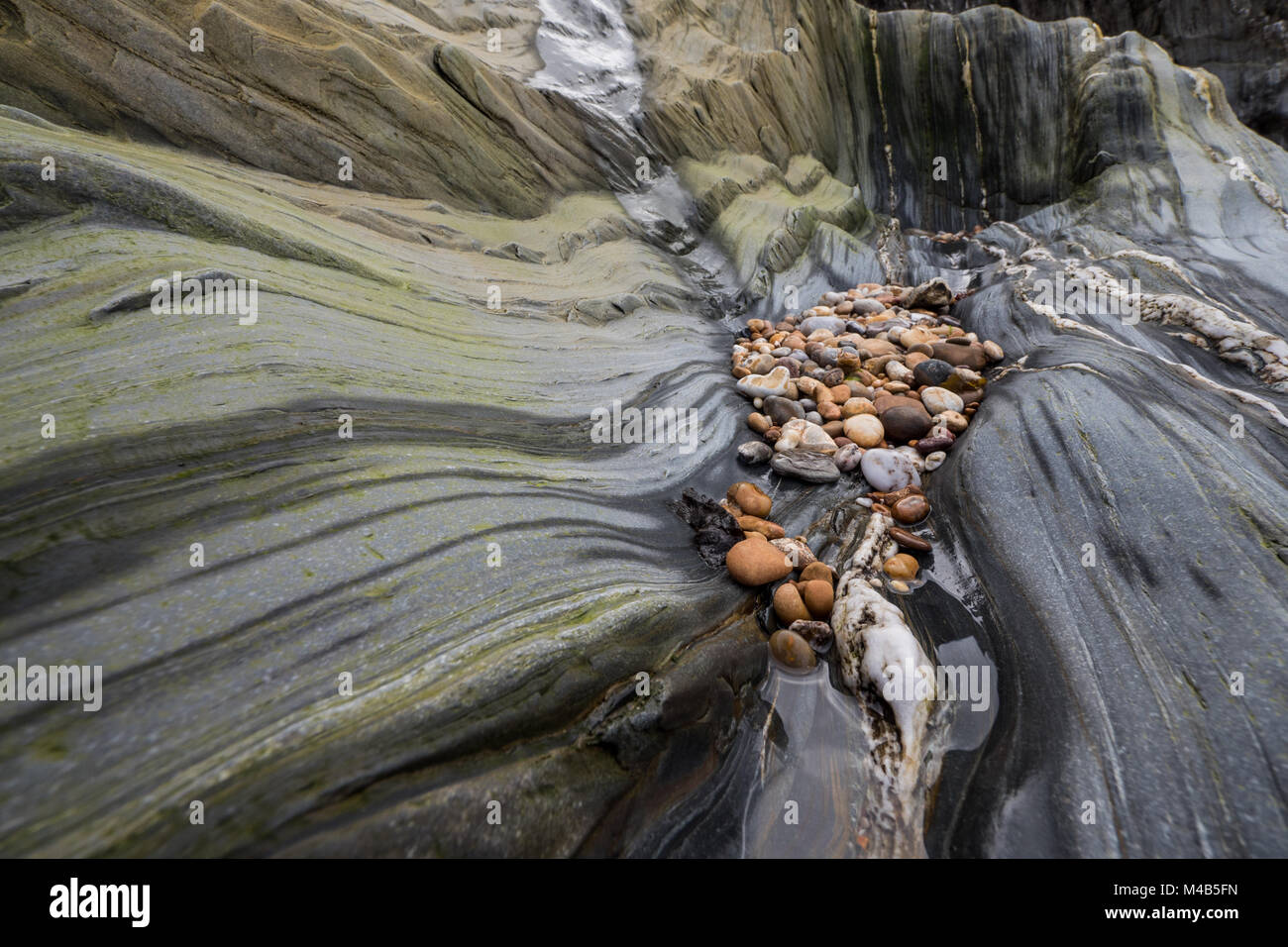 Coastal rocks and pebbles Stock Photo - Alamy