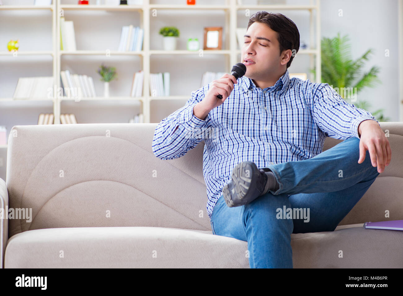 Funny man singing songs in karaoke at home Stock Photo - Alamy