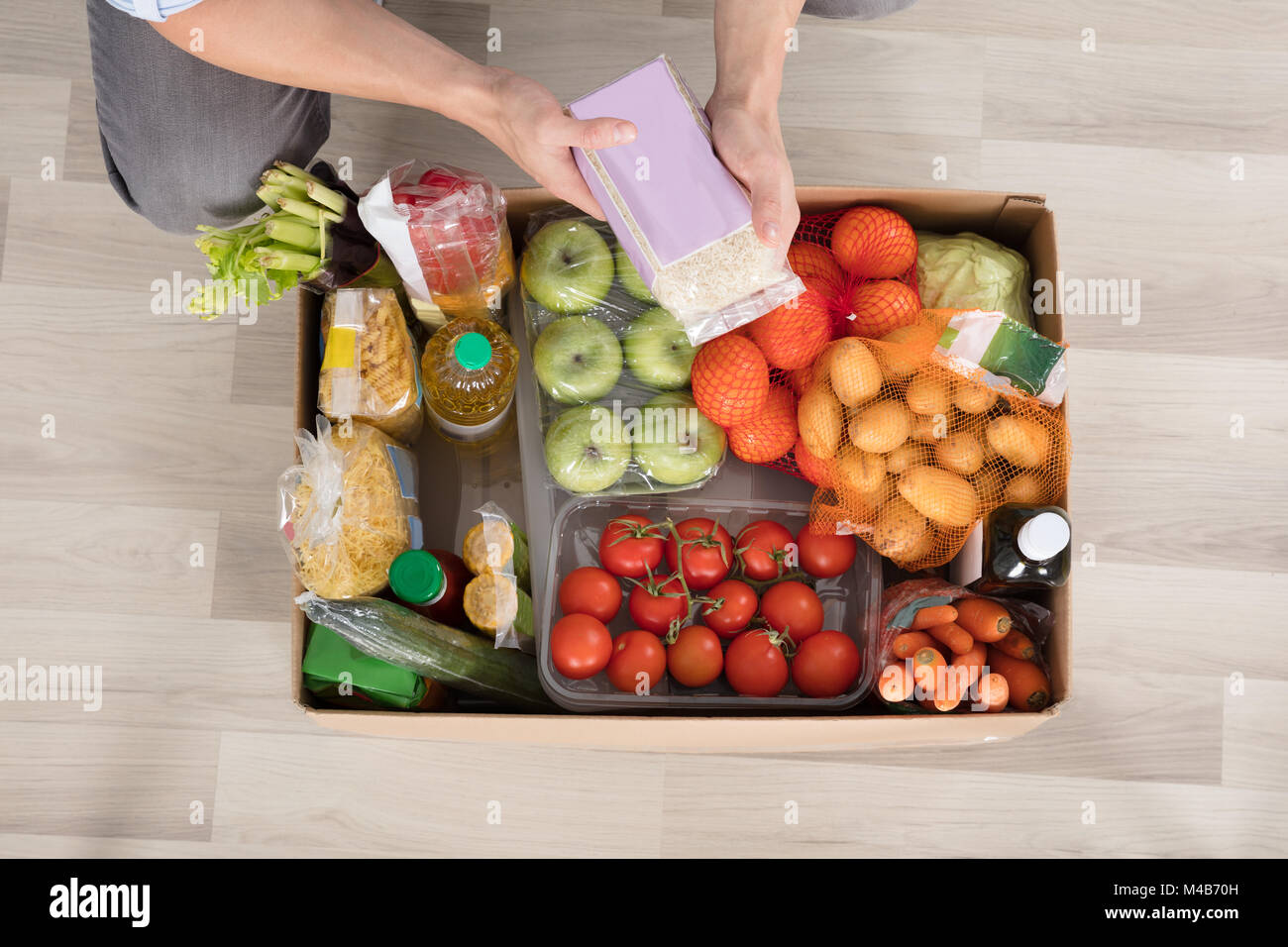 Overhead View Of A Man Checking The Groceries In The Cardboard Box ...